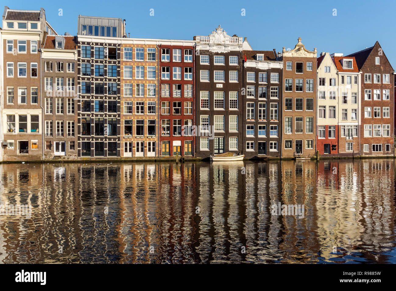 Traditional Dutch buildings at Damrak in Amsterdam, Netherlands Stock ...