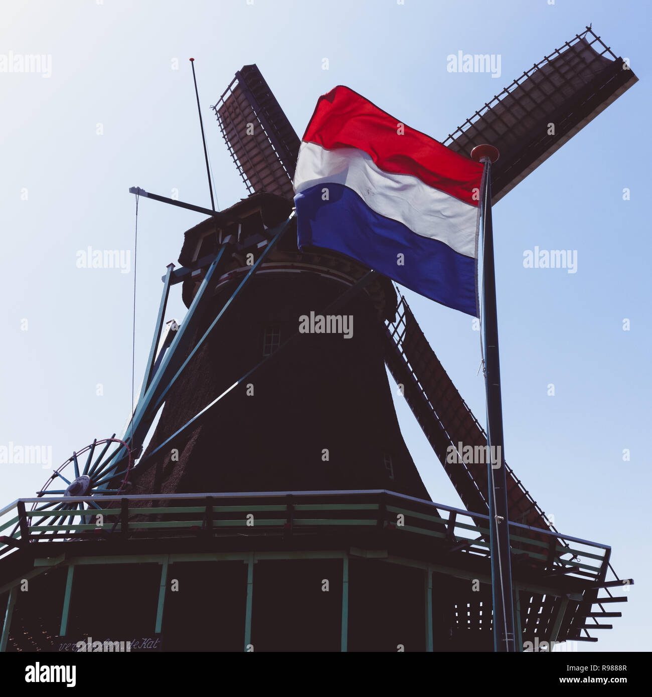 Dutch windmill and Dutch flag at Zaanse Schans in Netherlands Stock ...