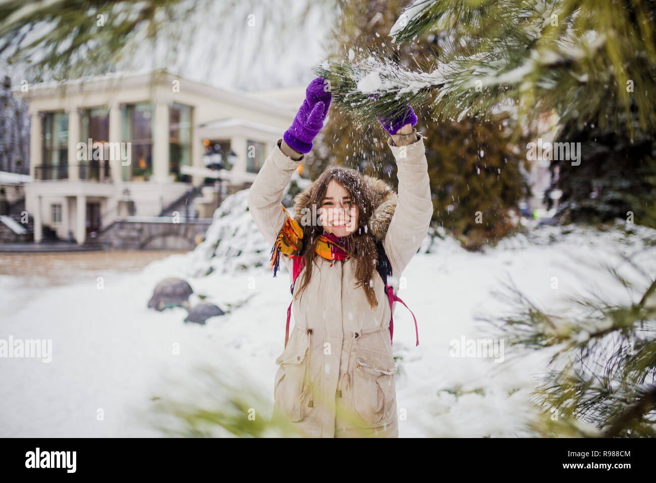 Beautiful young Caucasian woman joy happiness smile play with snow near ...