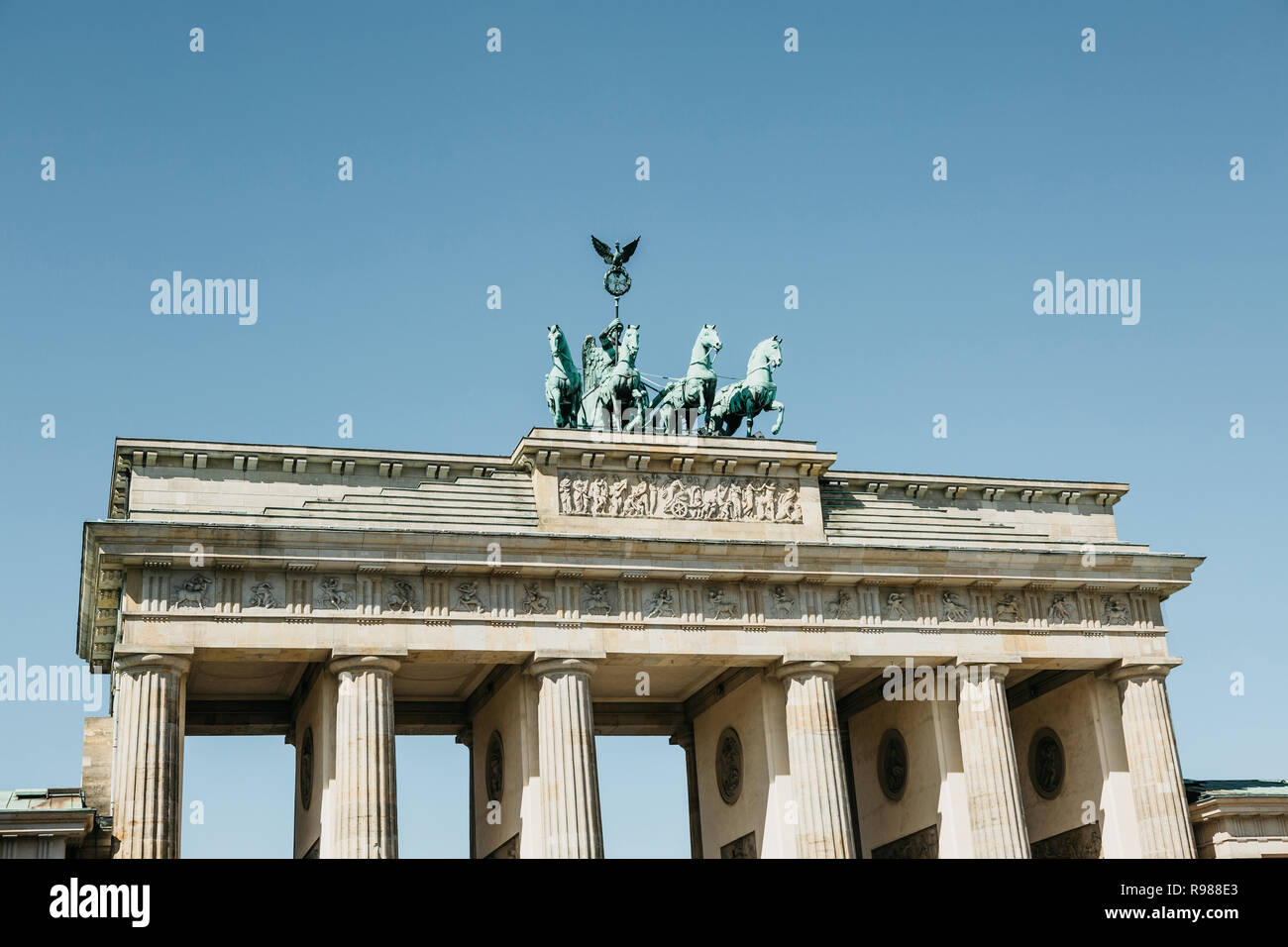 Closeup of the Brandenburg Gate against the blue sky. This is one of ...