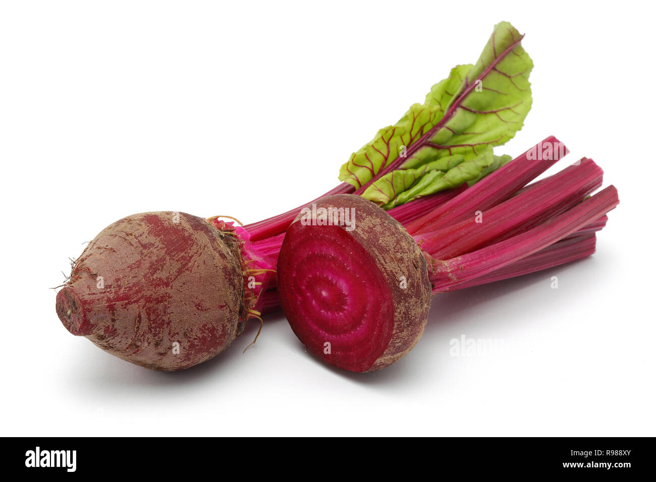 Fresh red beet roots and half with leaves isolated on white background ...