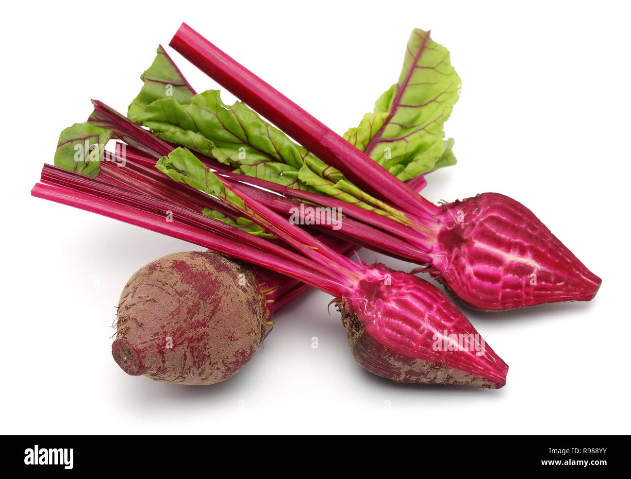 Fresh red beet root one cut in half and slice isolated on white ...