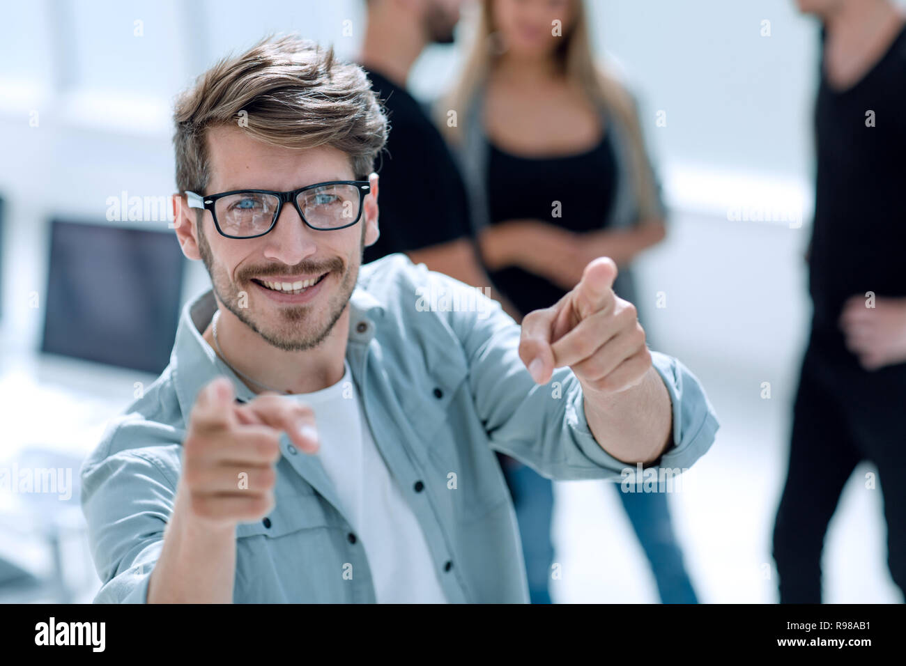 Smiling man pointing his finger to you Stock Photo - Alamy