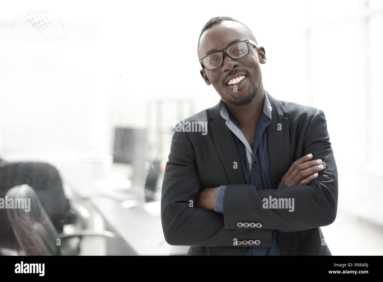 successful businessman looks through the window of the business cente ...