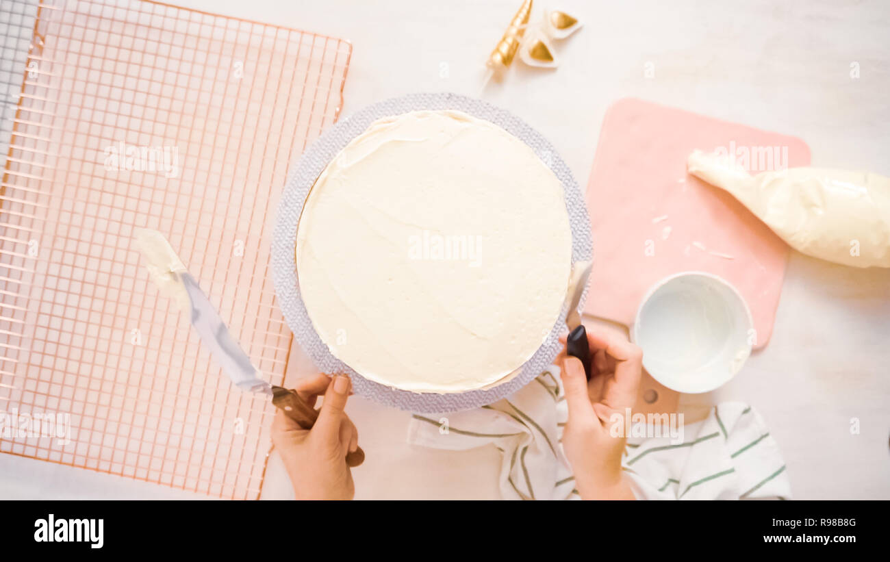Flat lay. Frosting pink and purple cake with a white buttercream icing ...
