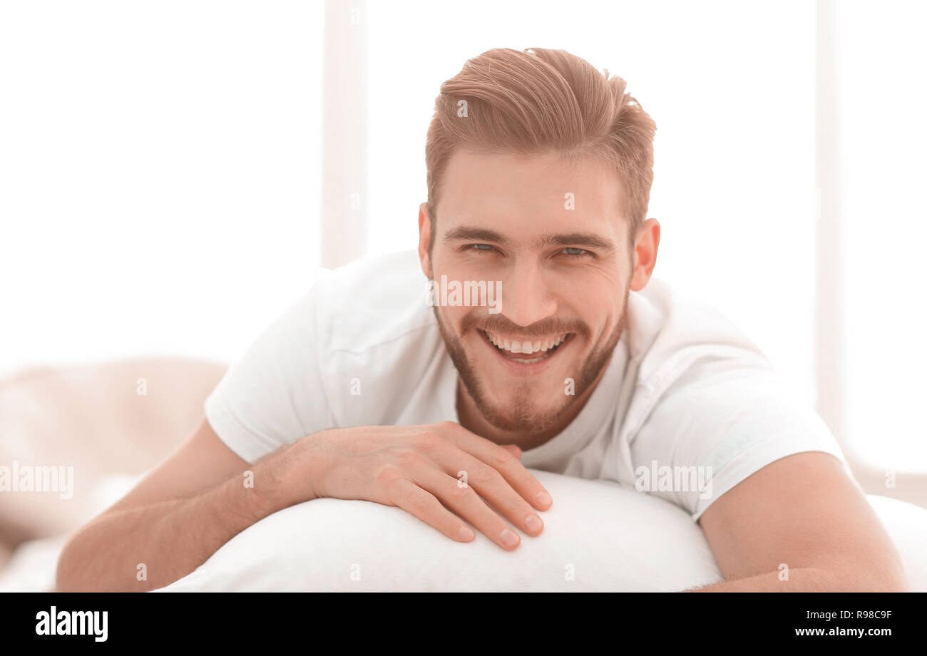 closeup.smiling man lying on the sofa Stock Photo - Alamy