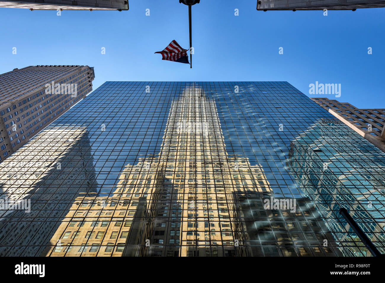The Chrysler Building visible in the reflection of surrounding office ...
