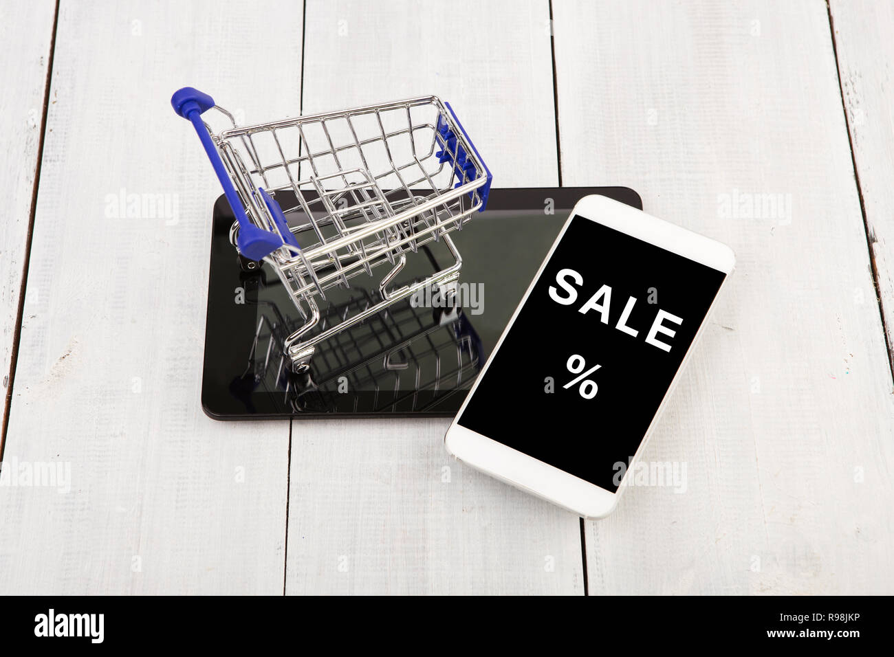 Shopping Cart on the tablet pc near to smartphone with inscription ...