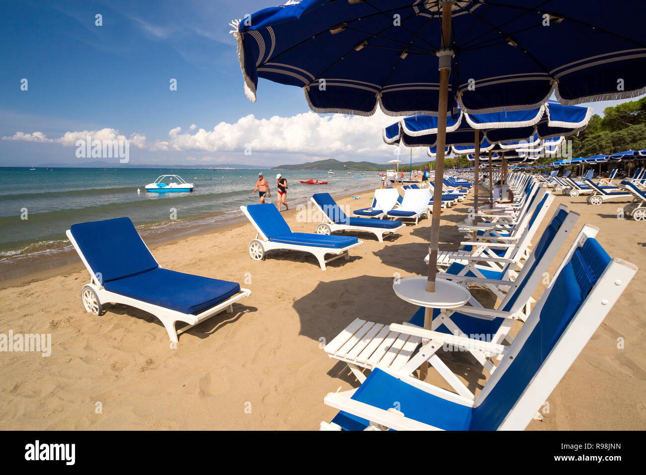 Sun loungers and umbrellas on beach at Punta Ala in Tuscany, Italy ...