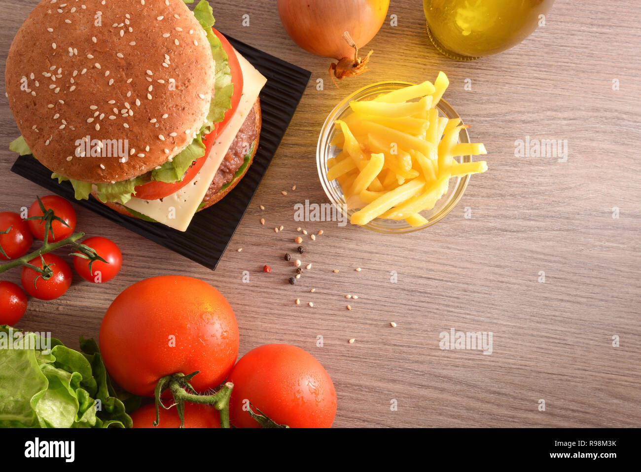 Homemade burger and ingredients for the preparation on wooden table ...