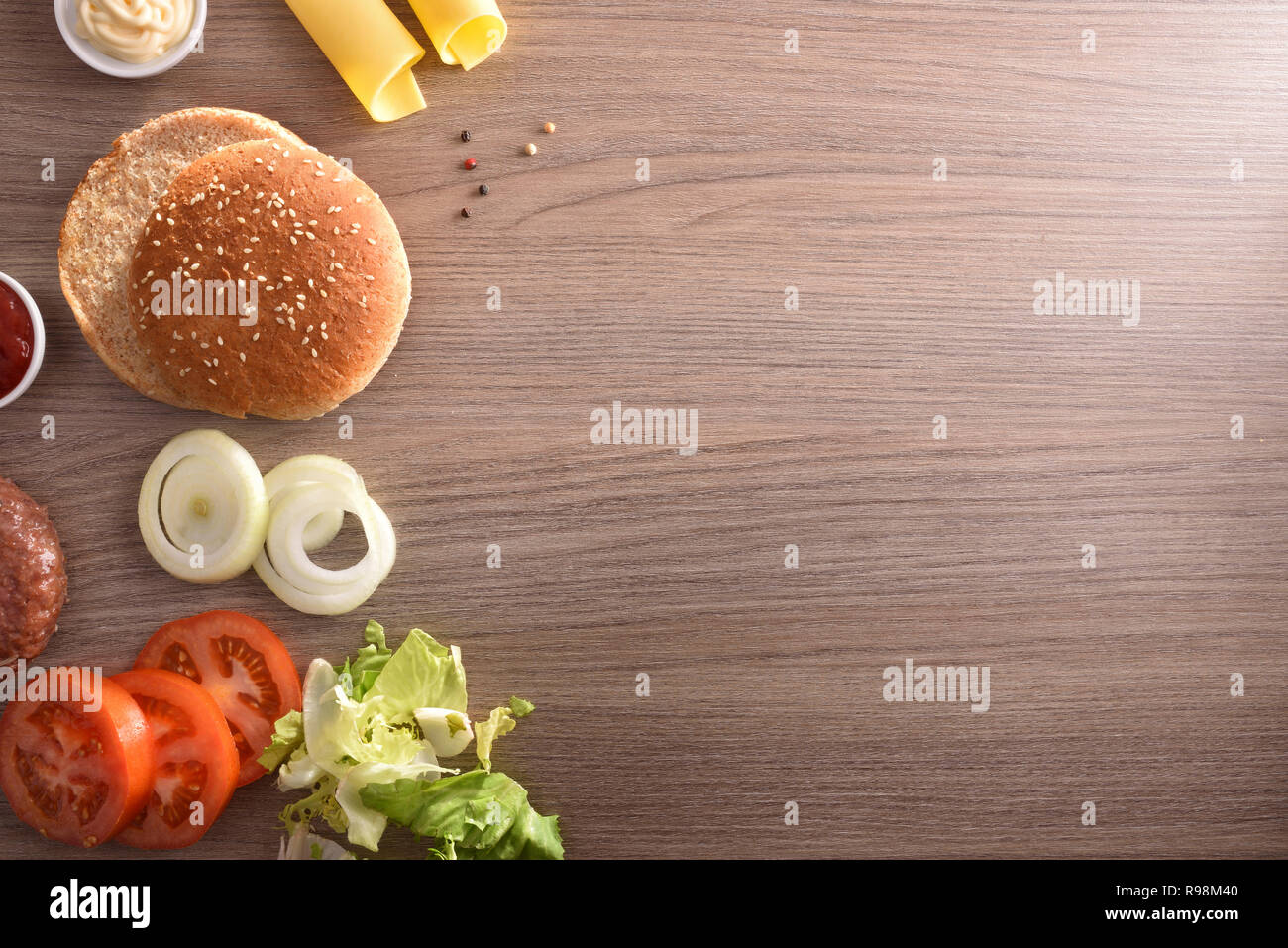 Ingredients for the preparation of a homemade burger on wooden table ...