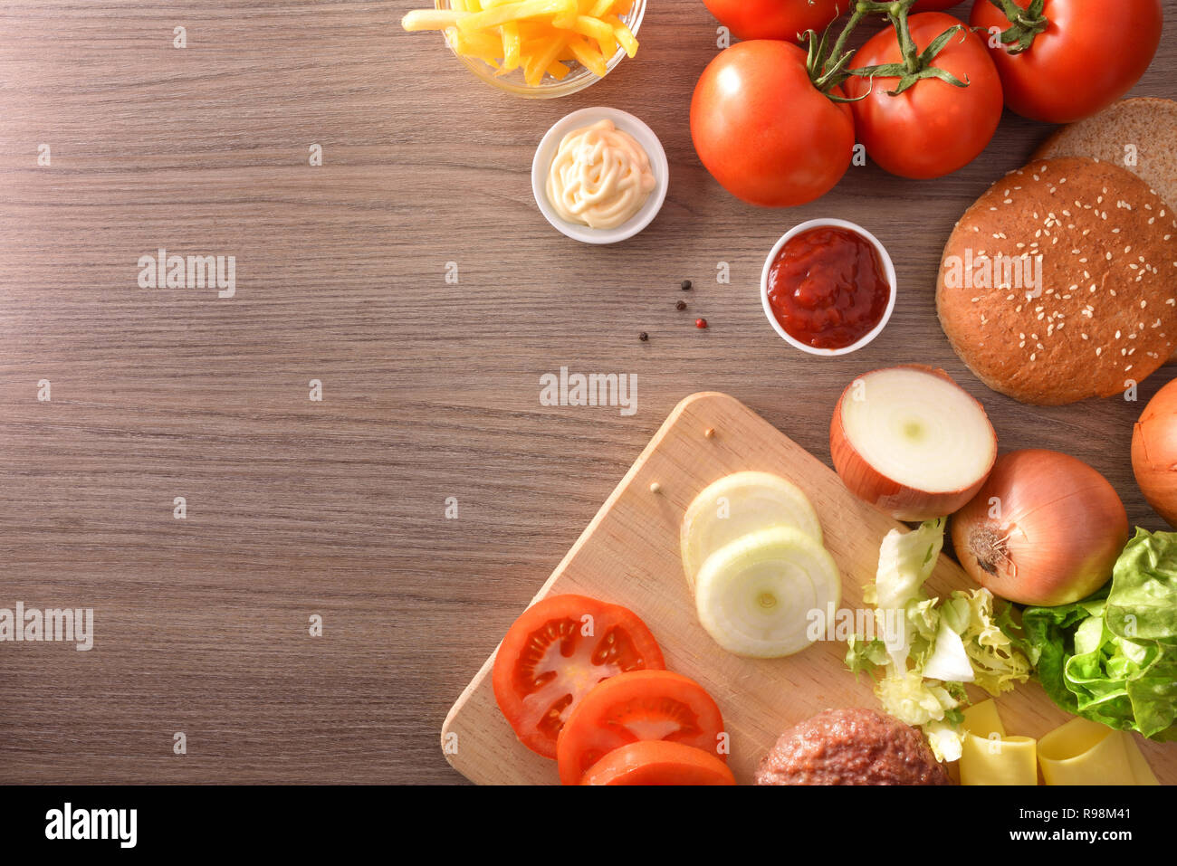 Ingredients for the preparation of a homemade burger on wooden table ...