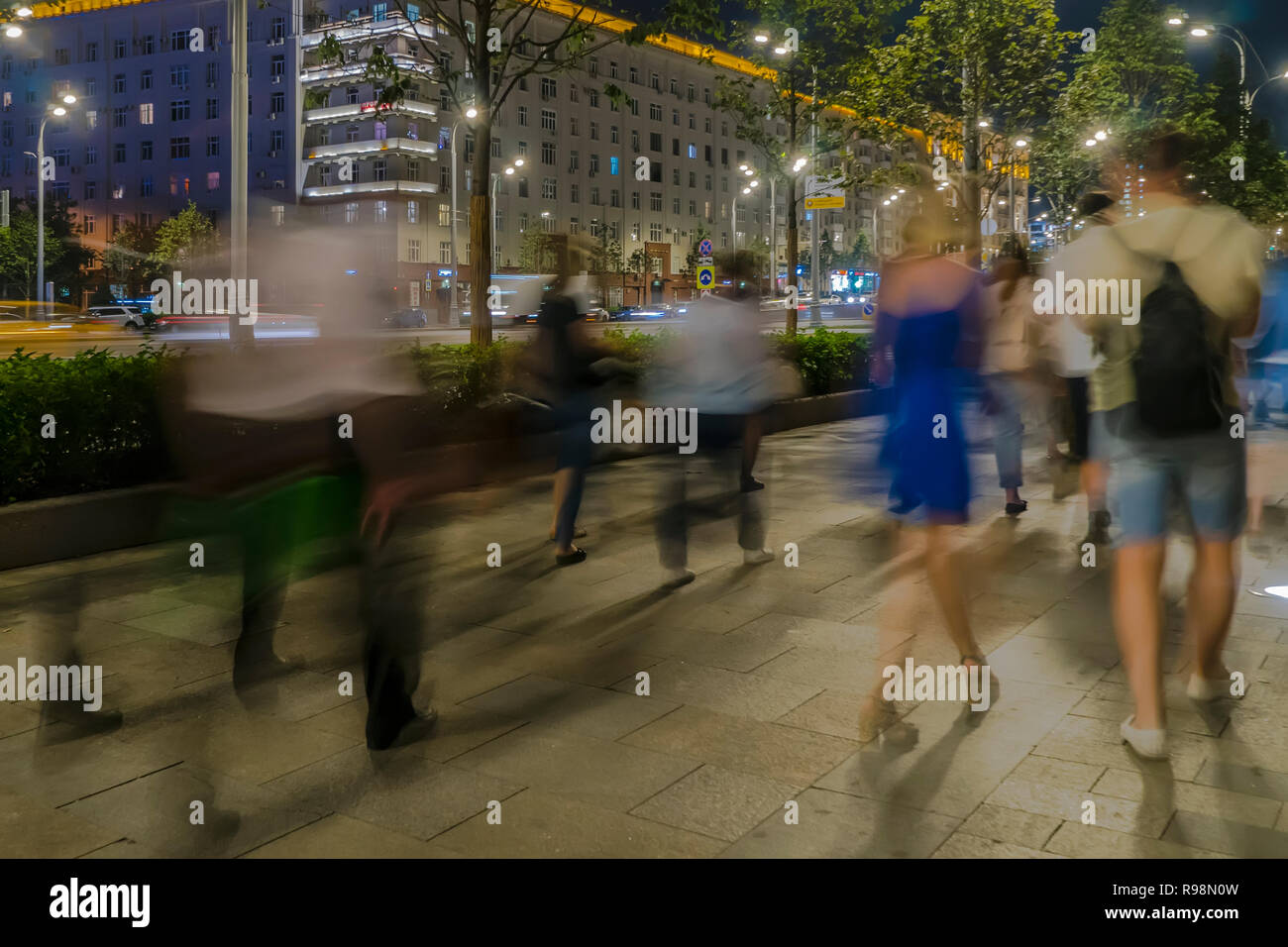 the flow of pedestrians and cars following the city street Stock Photo ...