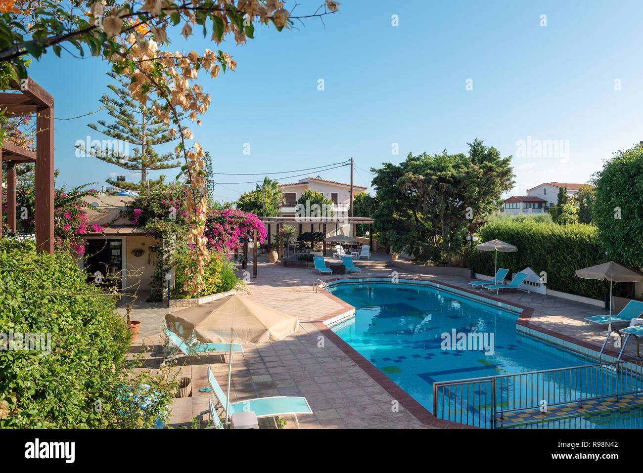 CRETE, GREECE - AUGUST 2018: Swimming pool with clean water and sunbeds ...