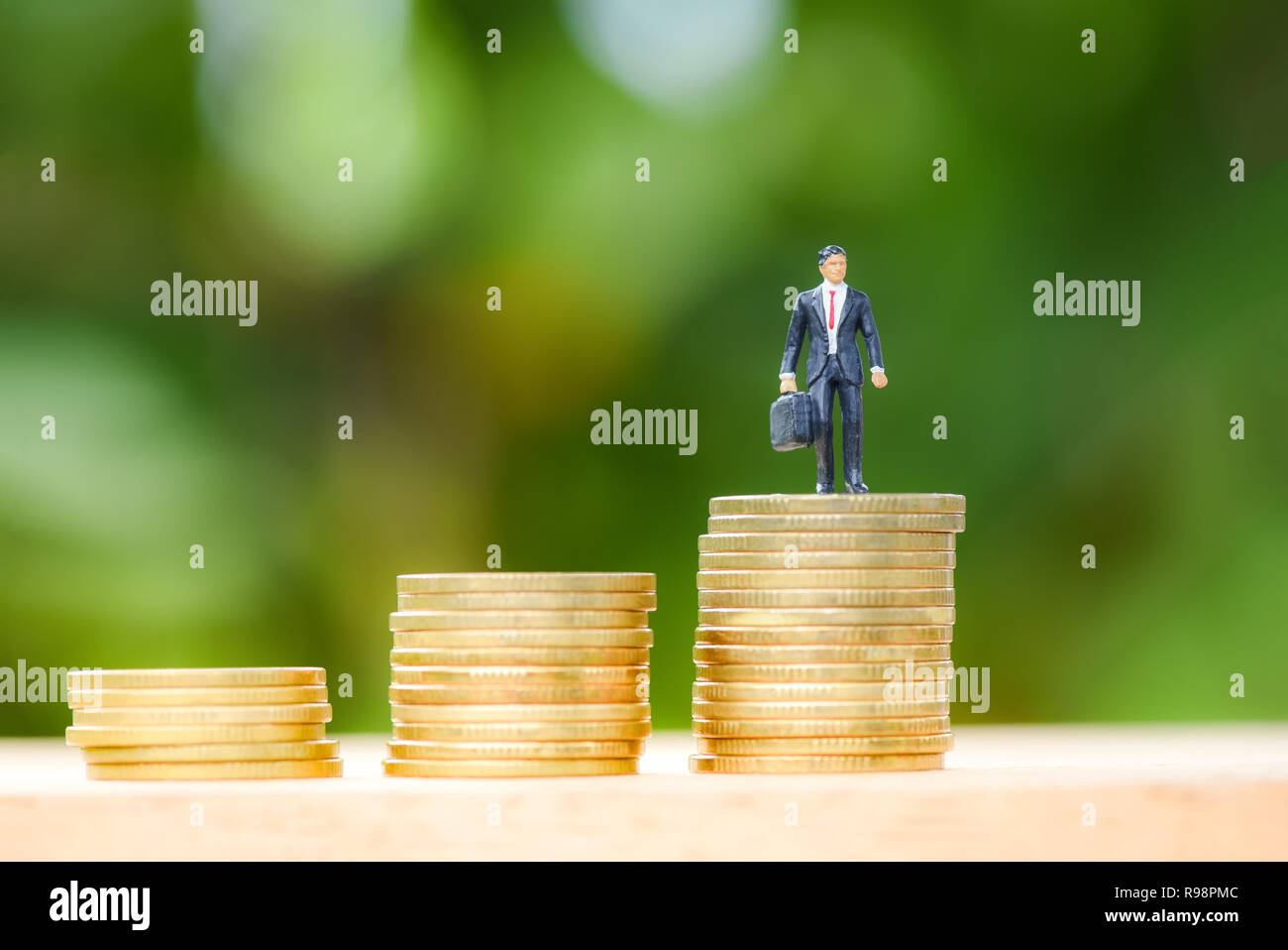 gold coin step up success concept planning / holding briefcase bag ...