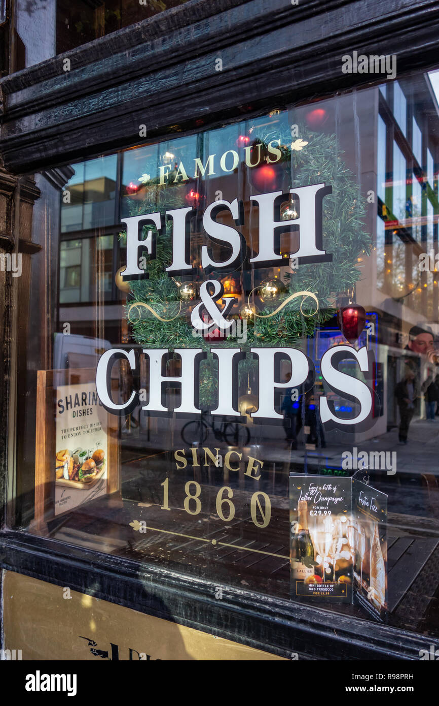 Closeup of Fish and Chip shop sign with Lettering stuck on a Pub window ...