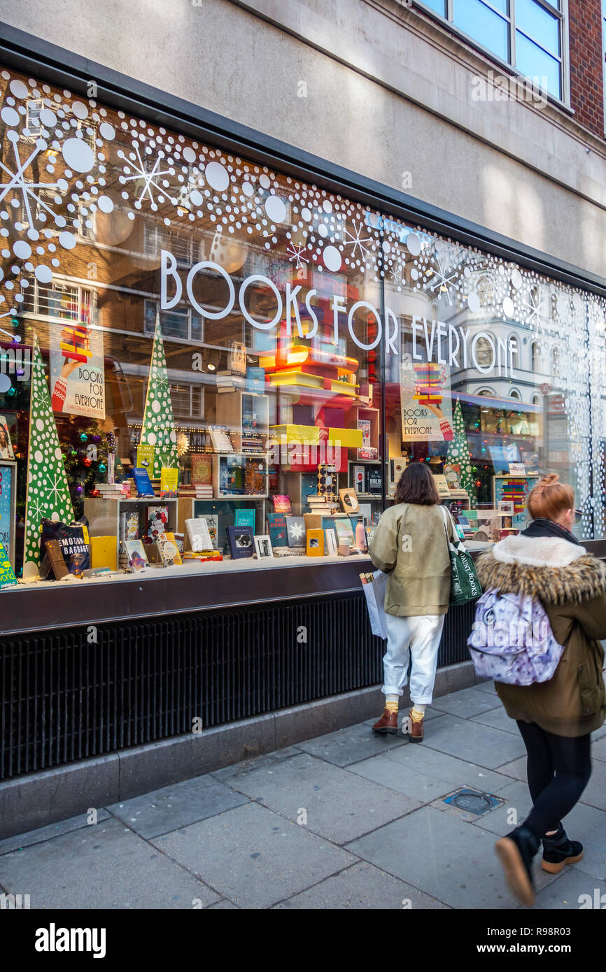Woman looking at the shop front window display at Foyles bookshop ...