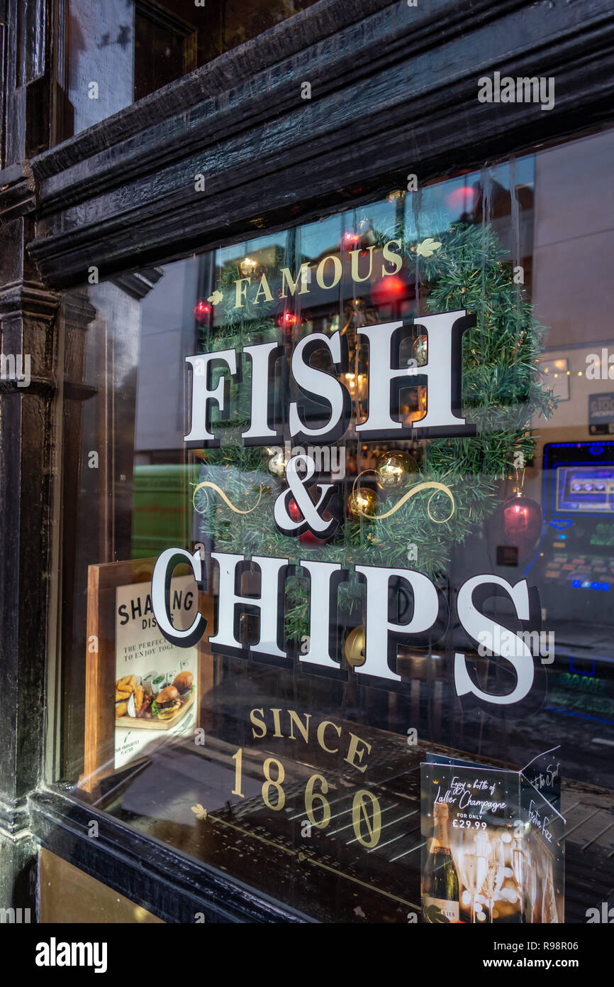 Closeup of Fish and Chip shop sign with Lettering stuck on a Pub window ...