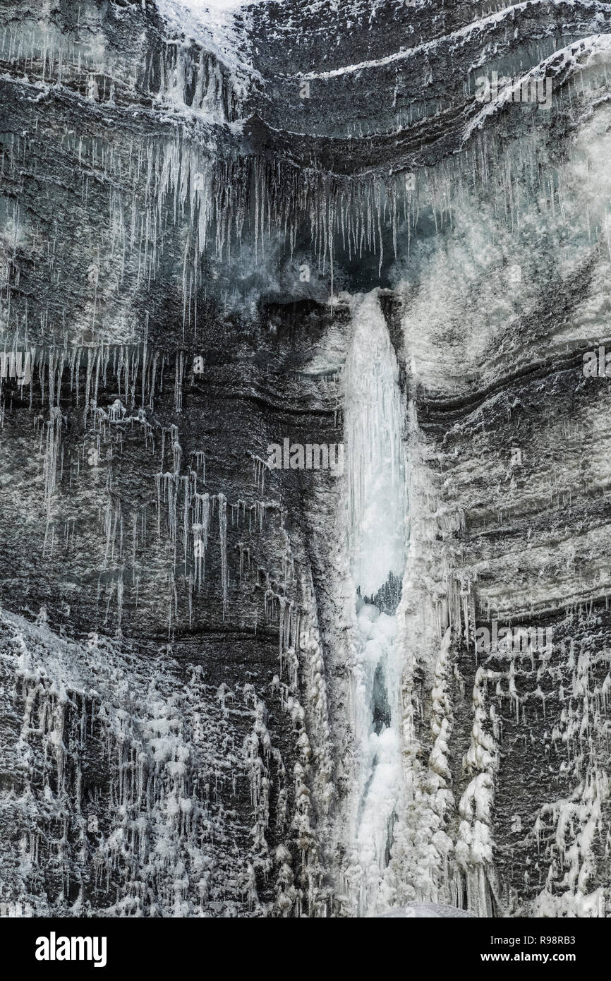 Frozen waterfall from water falling from an ice cave in a lobe of ...