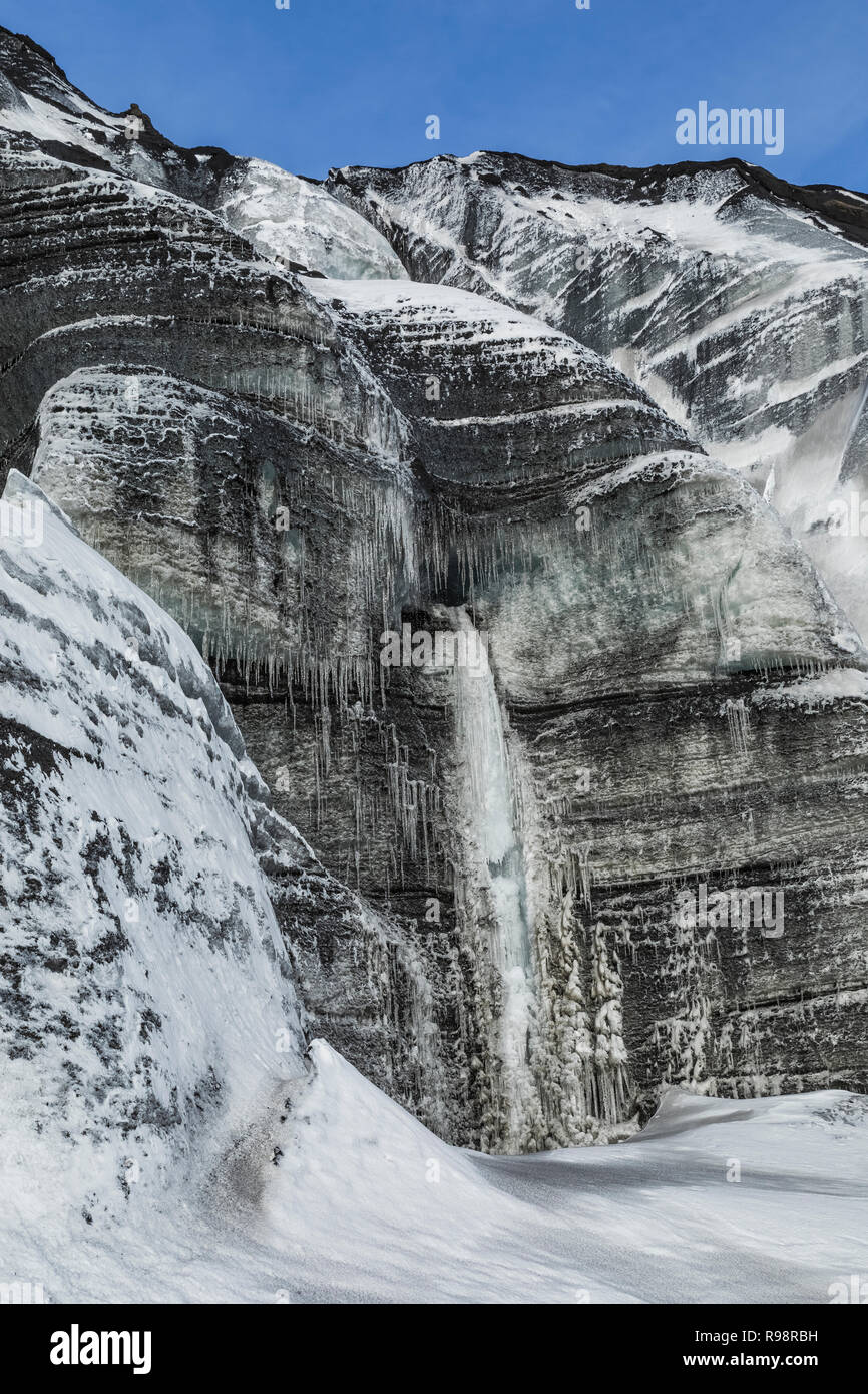 Frozen waterfall from water falling from an ice cave in a lobe of ...