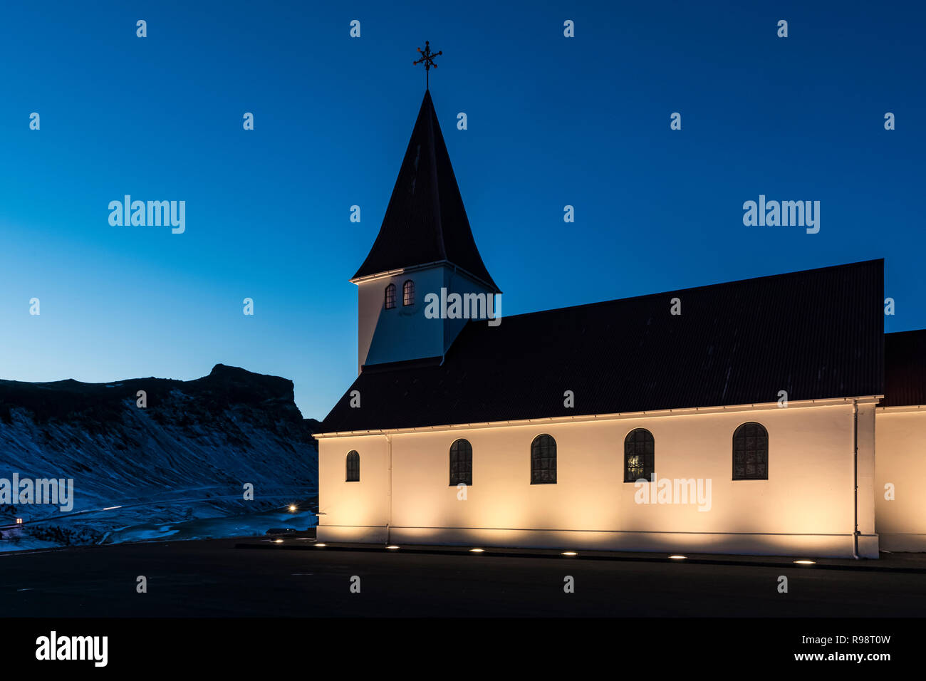 The beautifully illuminated Vik Church stands dramatically over the ...