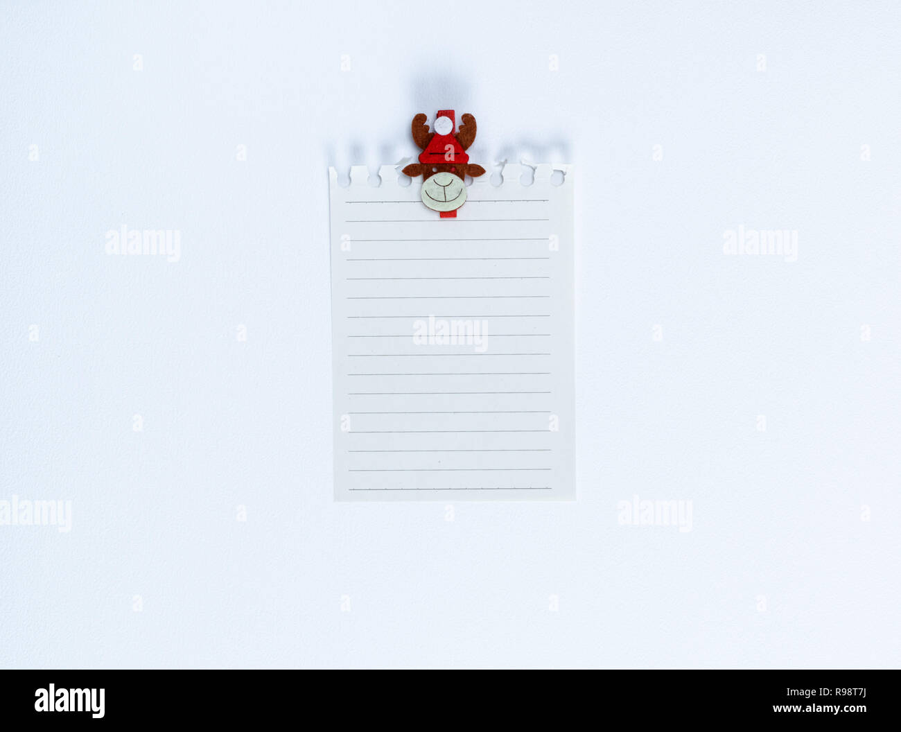 white blank sheet in a line torn out of notepad on a white background ...