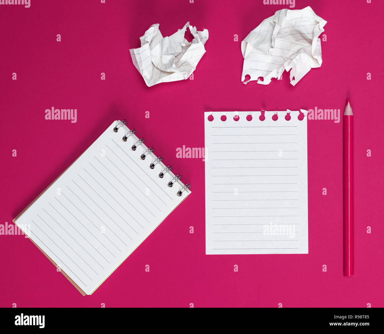 open notebook with white sheets and a crumpled ripped out sheet of ...