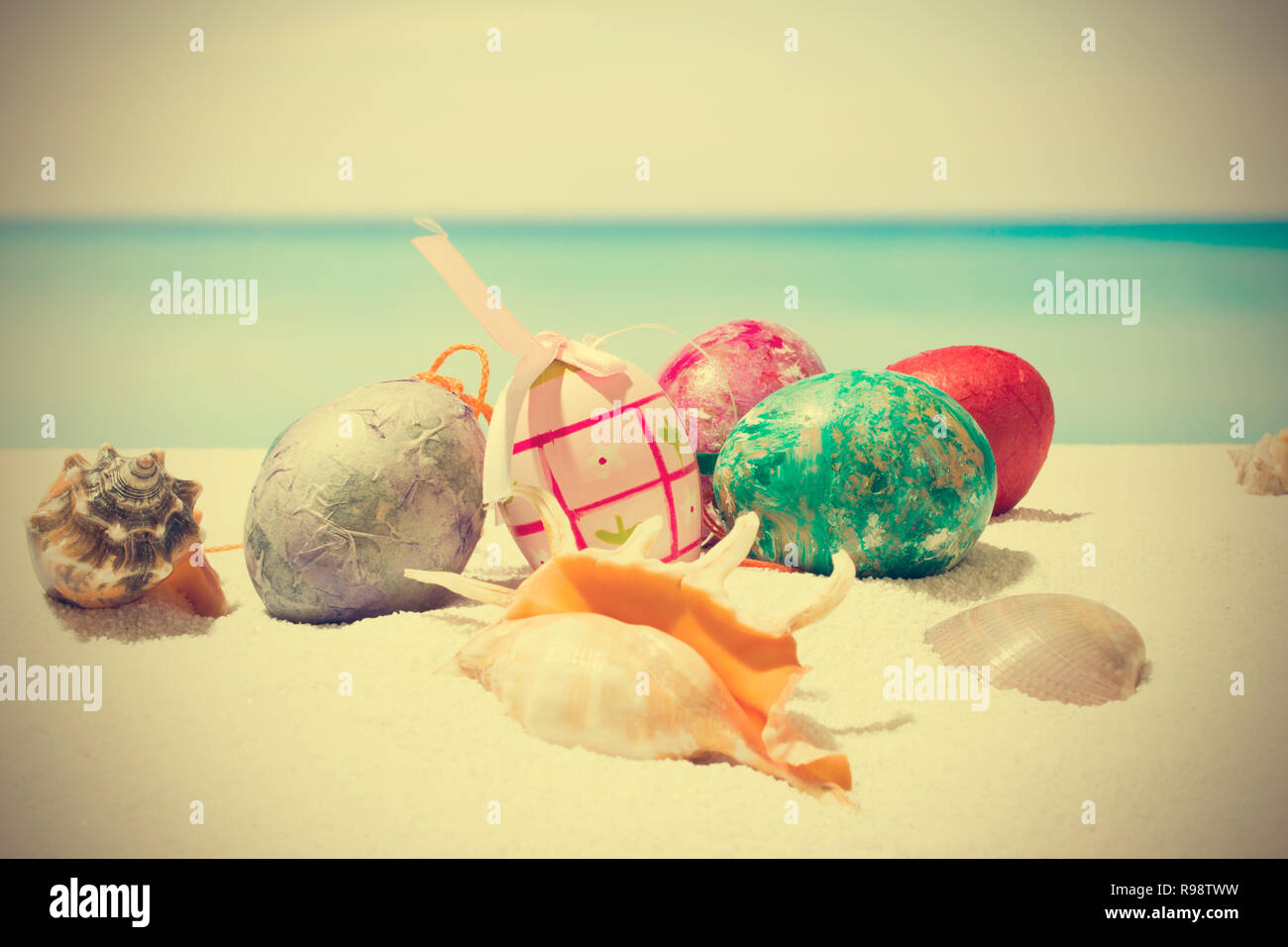 Easter on tropical beach background. Eggs on the white sand. Vacation ...