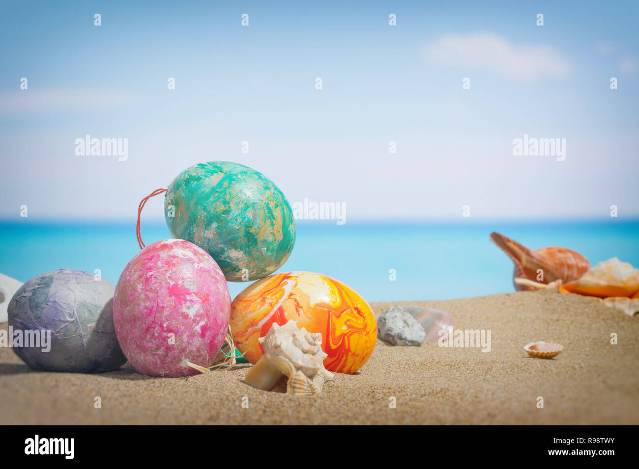 Easter on beach background. Eggs on the sandy by the ocean. Vacation ...