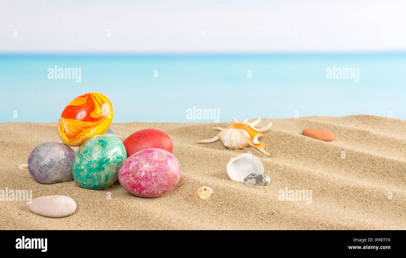 Easter on beach background. Eggs on the sandy by the ocean. Vacation ...