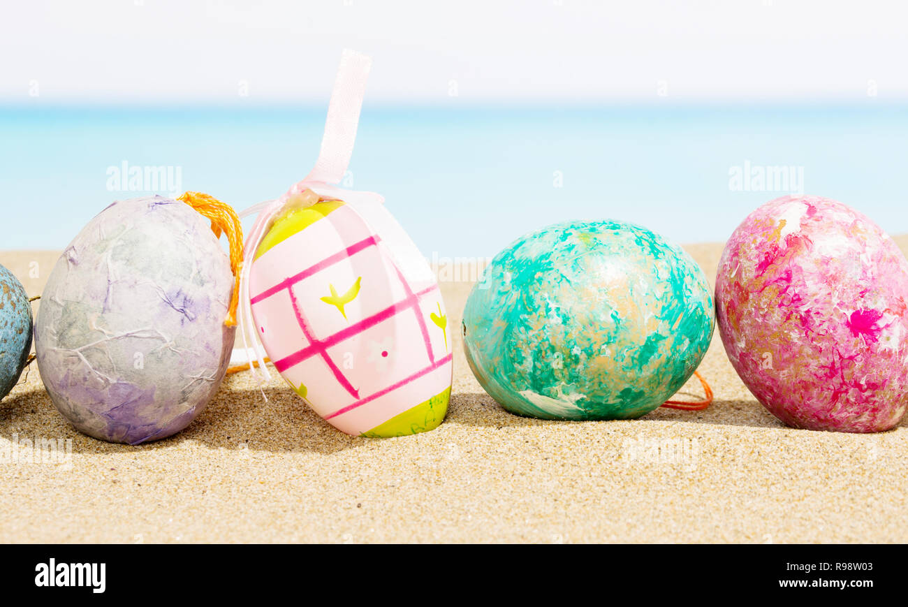 Easter on beach background. Eggs on the sandy by the ocean. Vacation ...