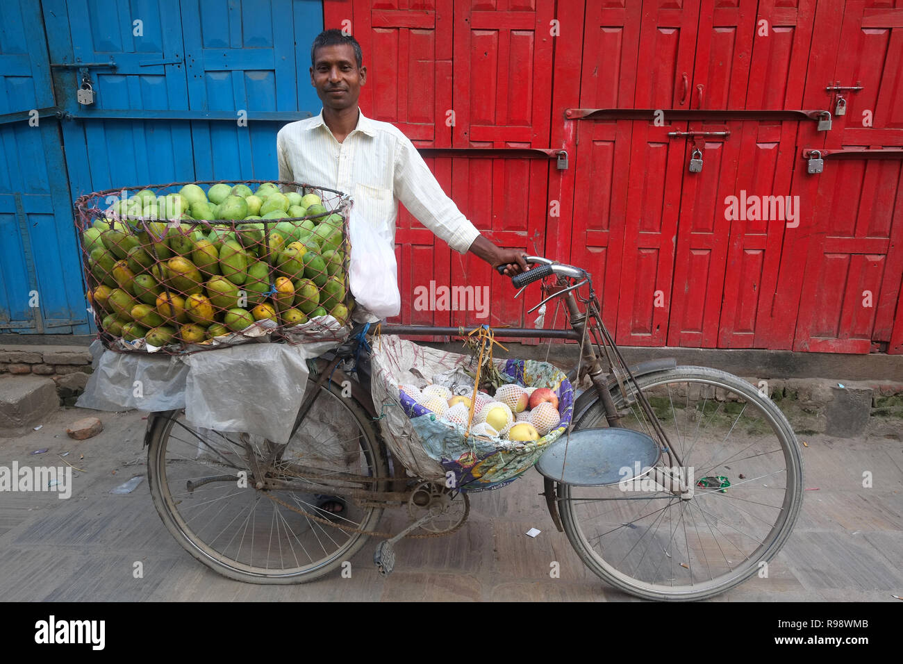 A mobile mango vendor, a migrant from Bihar in Northern India, plying ...
