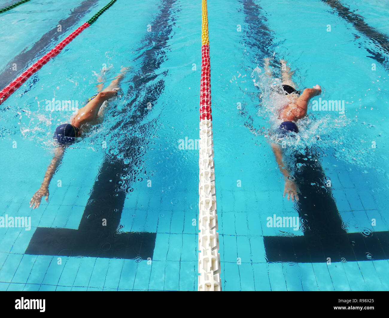 swimmers in lane pool, men in water Stock Photo - Alamy