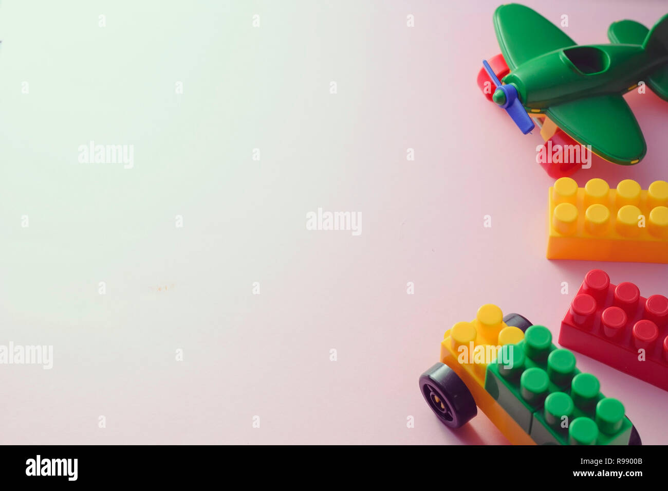 Border of colorful plastic kids toys with building blocks, airplane on ...