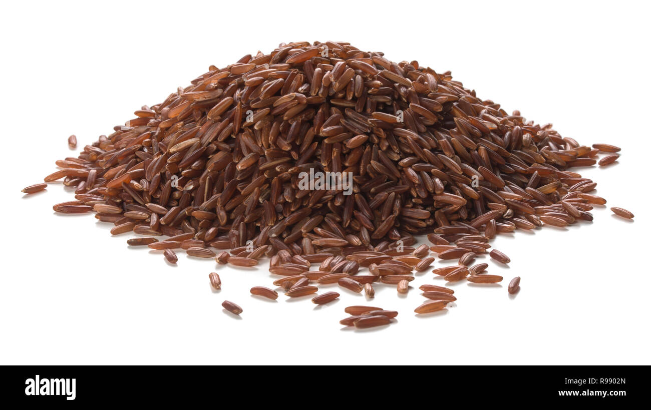 Close up photography of long grain red rice heap over white background ...