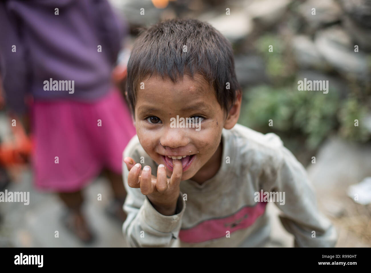 Nepali boy smile and makes grimace Stock Photo - Alamy
