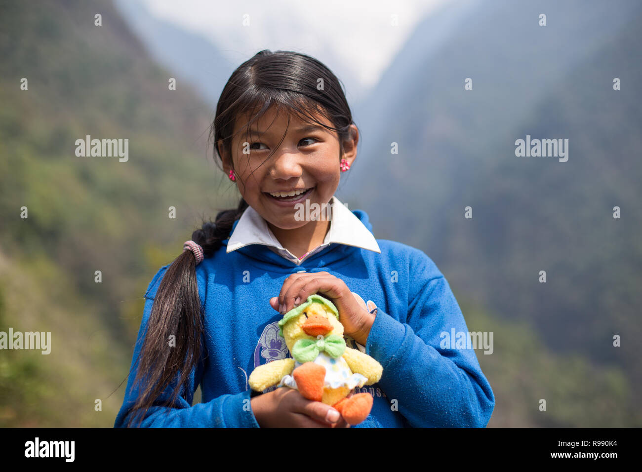 Himalayan girl pose for camera with stuffed toy and smile Stock Photo ...