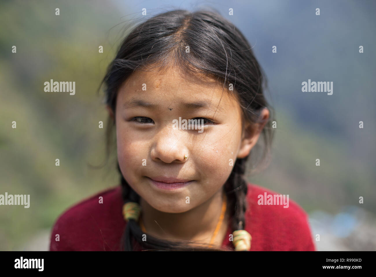 Himalayan girl pose for camera with stuffed toy and smile Stock Photo ...