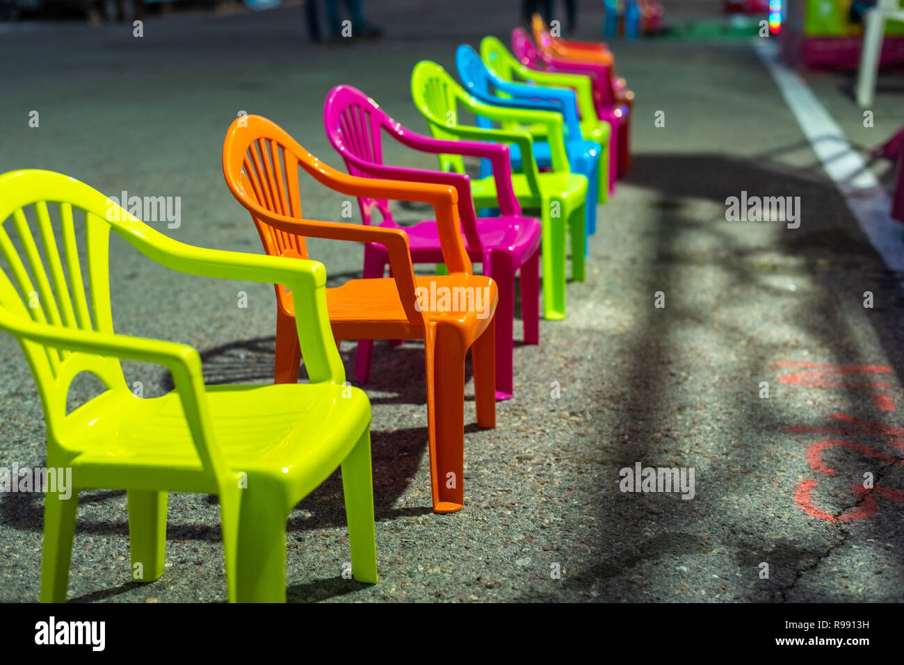 Child seats of various colors in a row Stock Photo - Alamy