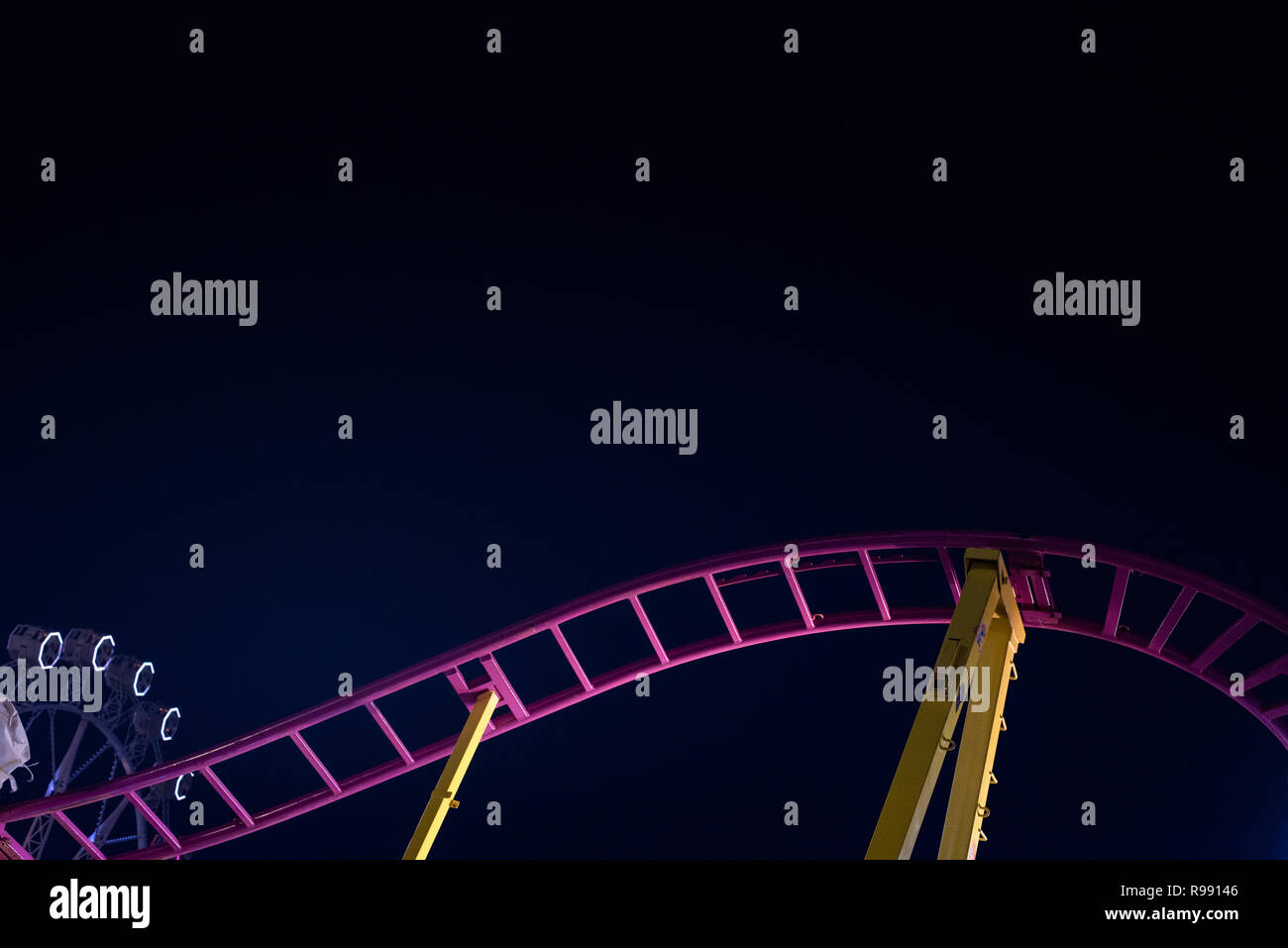 Rails of a roller coaster, blue night sky background Stock Photo - Alamy