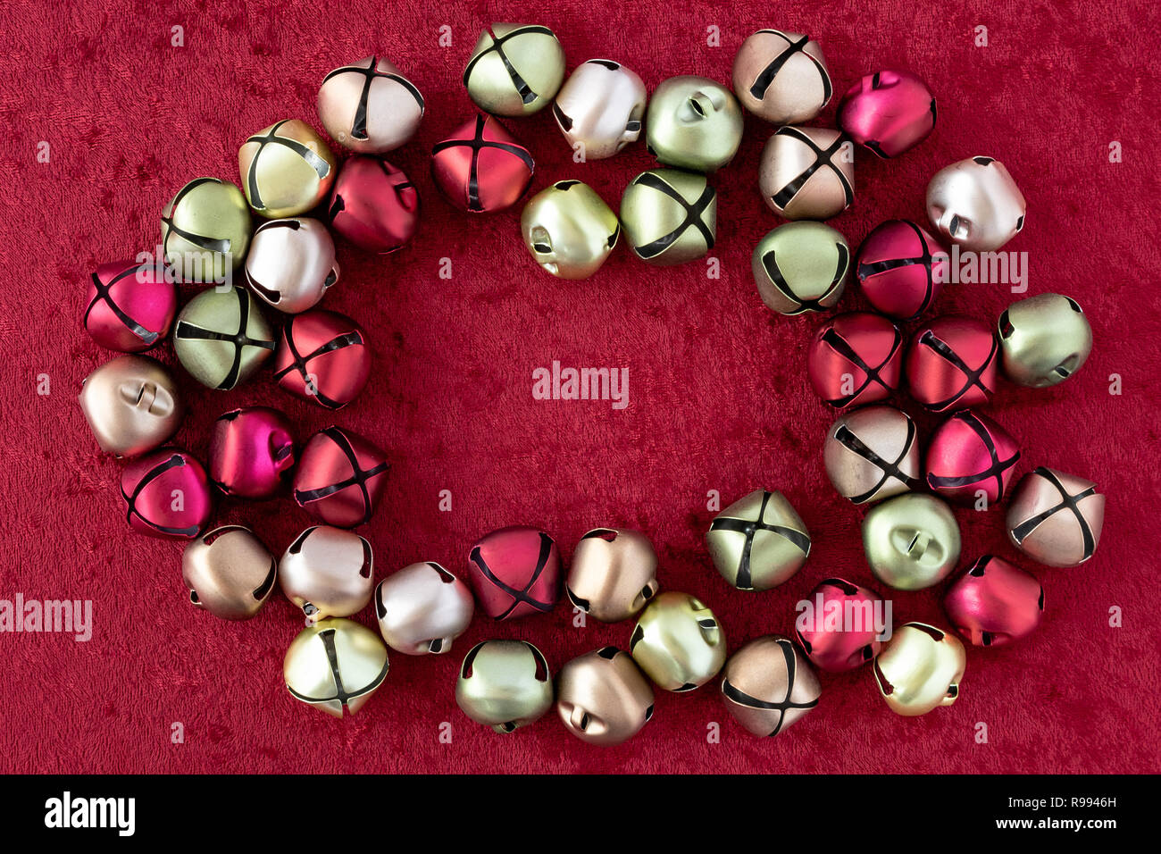 Red, green, gold, and silver in a round framed shape on a red velvet ...