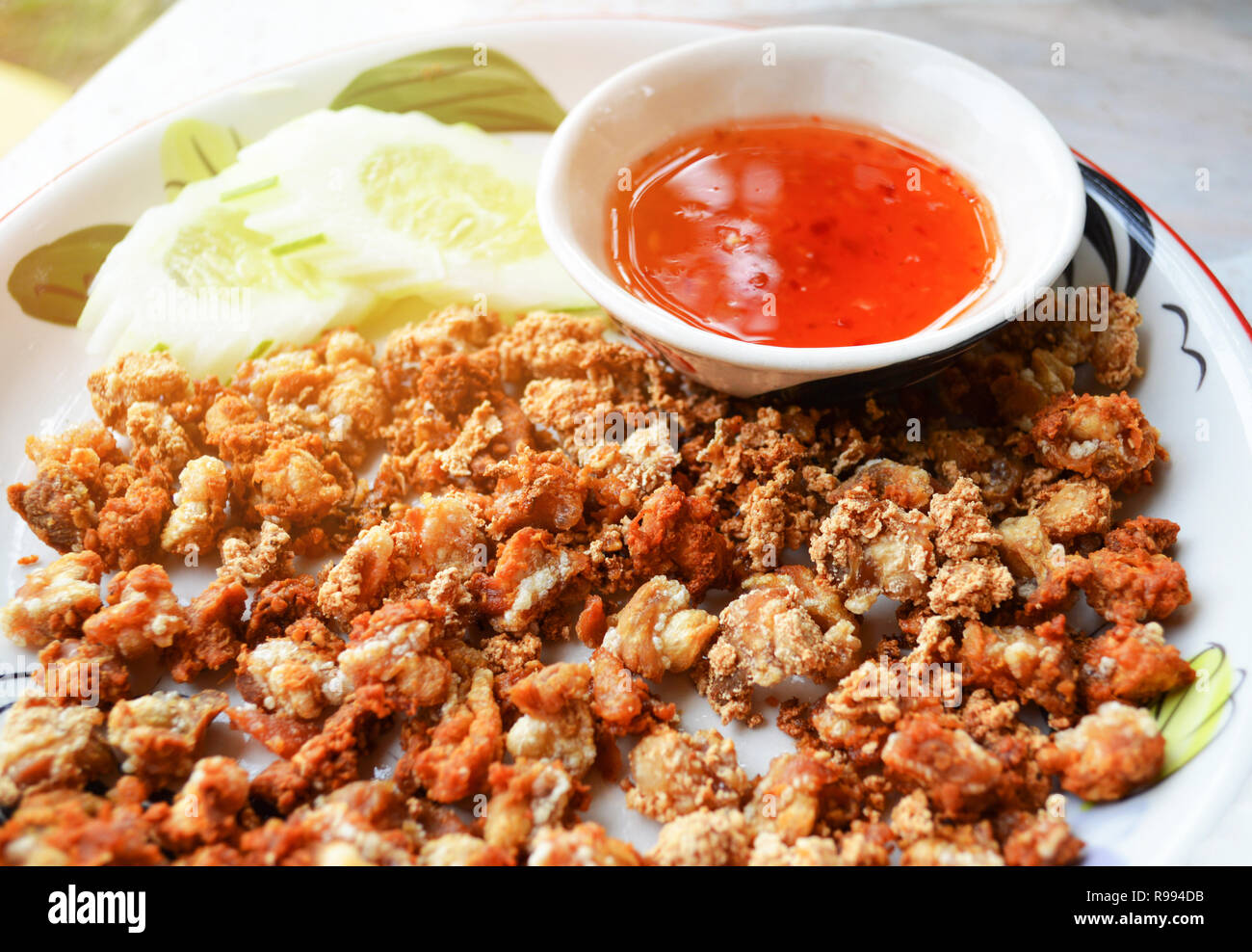 Deep fried chicken tendons with garlic and chilli sauce on plate for ...