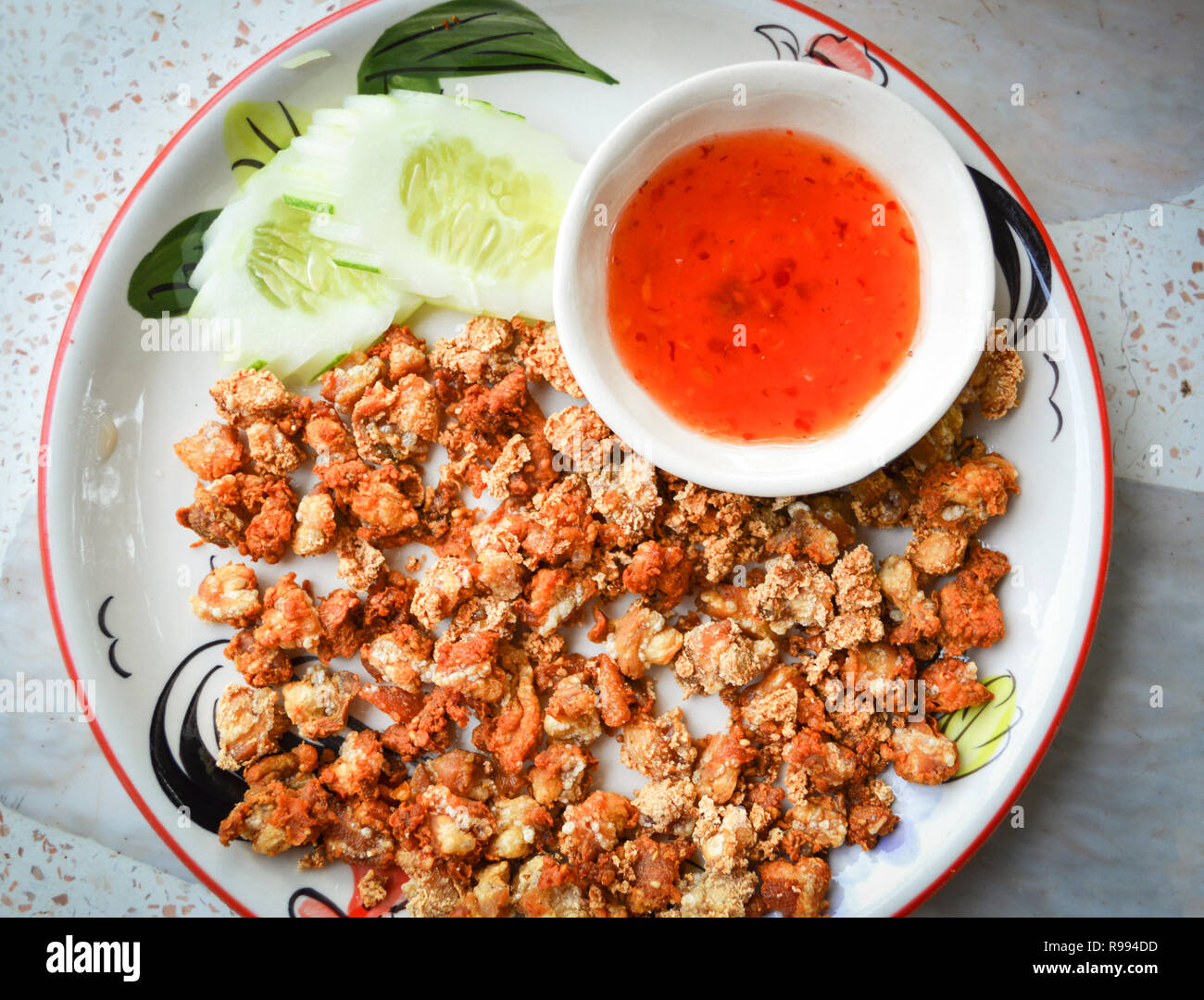 Deep fried chicken tendons with garlic and chilli sauce on plate for ...