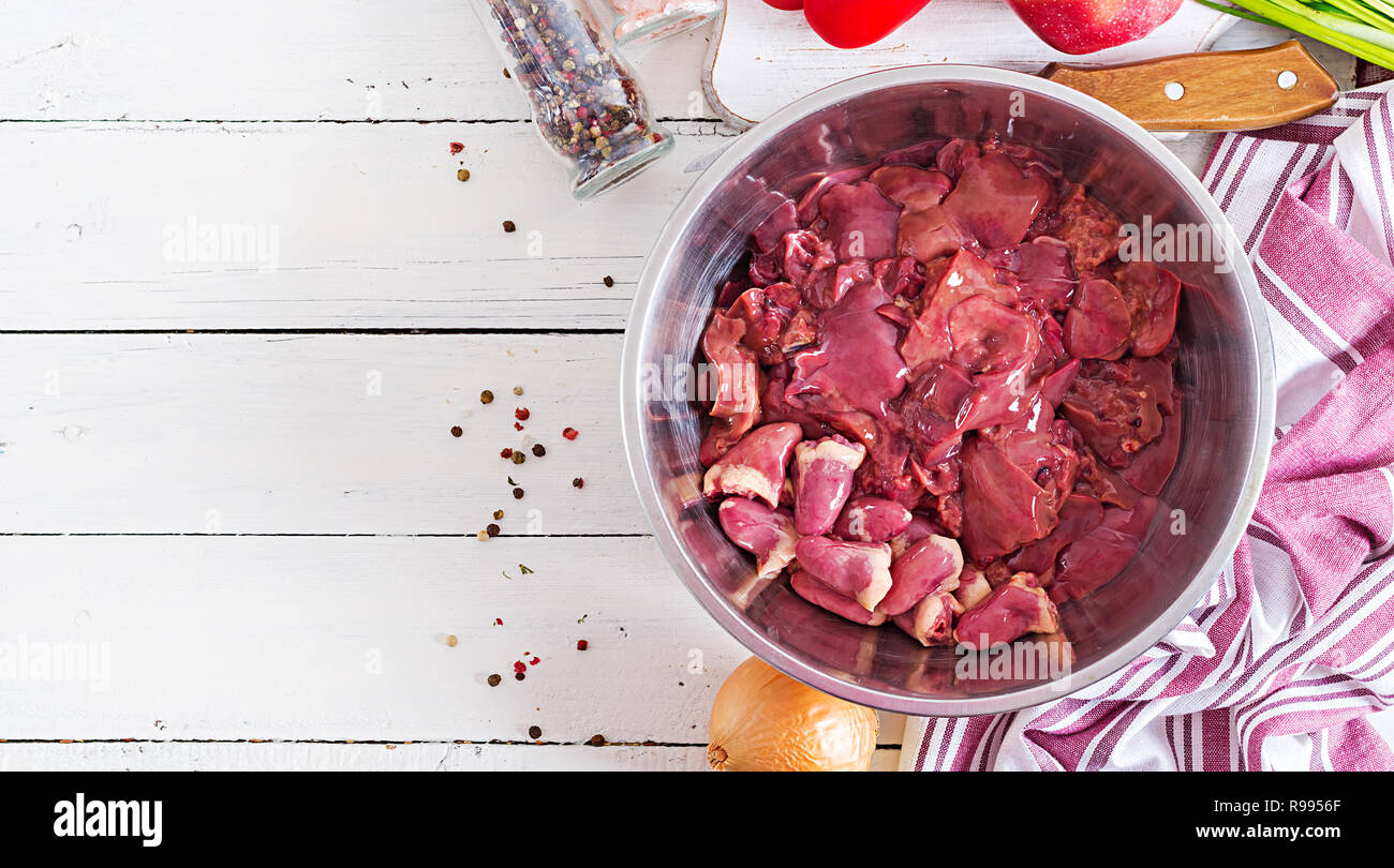 Raw chicken liver in bowl on white wooden background. Food ingredient ...