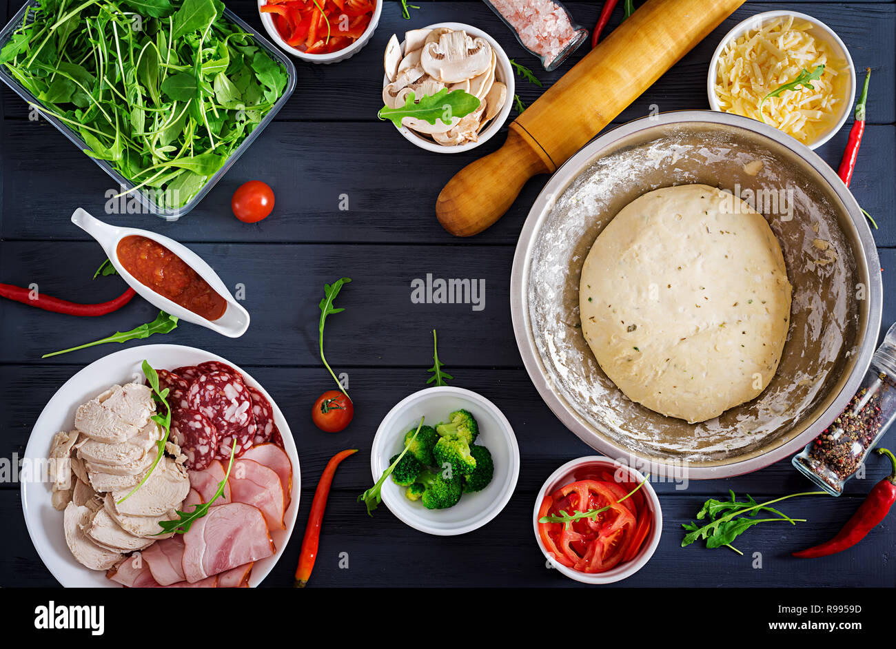 Italian pizza. Dough and pizza ingredients. Dough, cheese, tomatoes ...