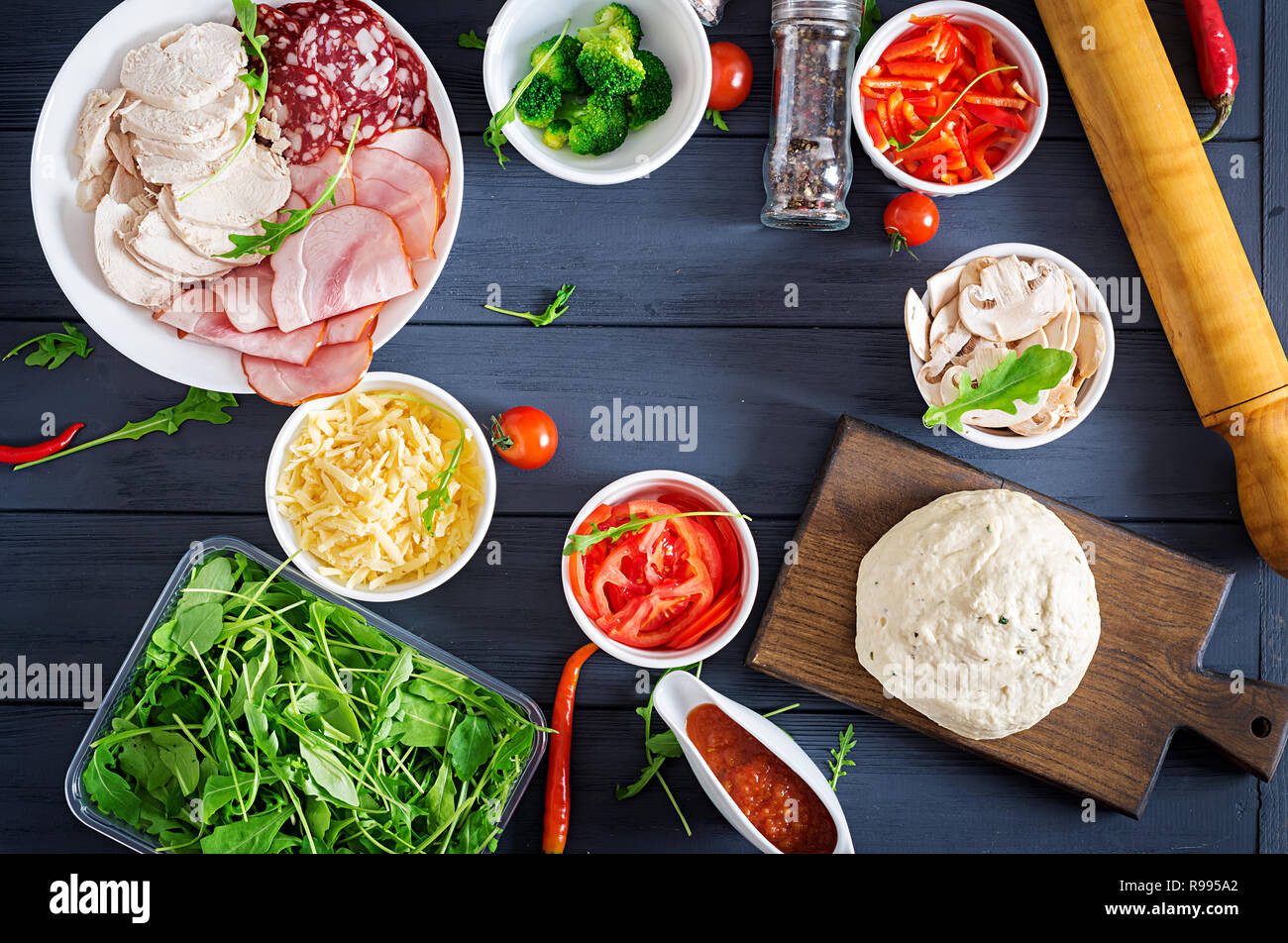 Italian pizza. Dough and pizza ingredients. Dough, cheese, tomatoes ...