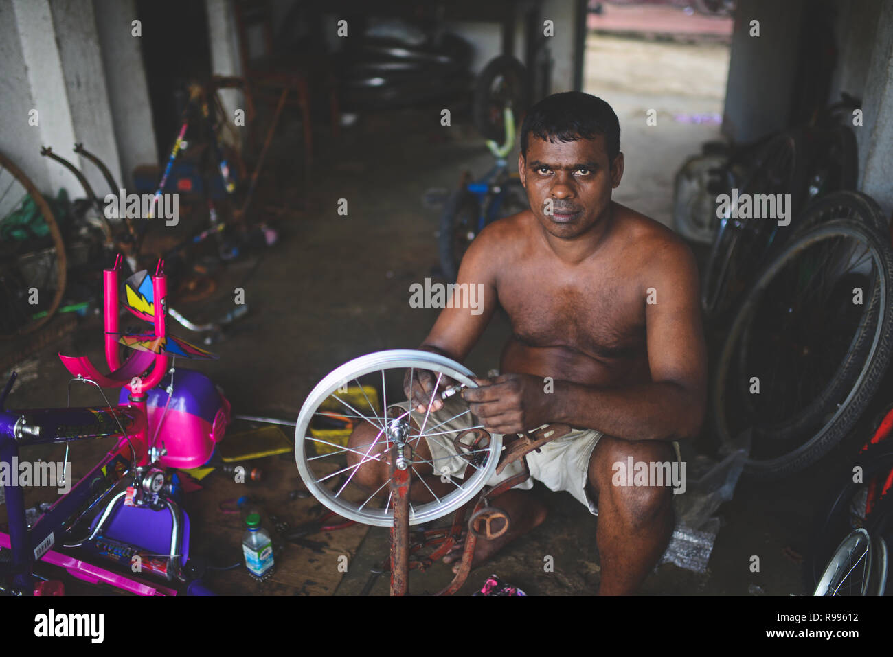 Man fixing his bicycle hi-res stock photography and images - Alamy