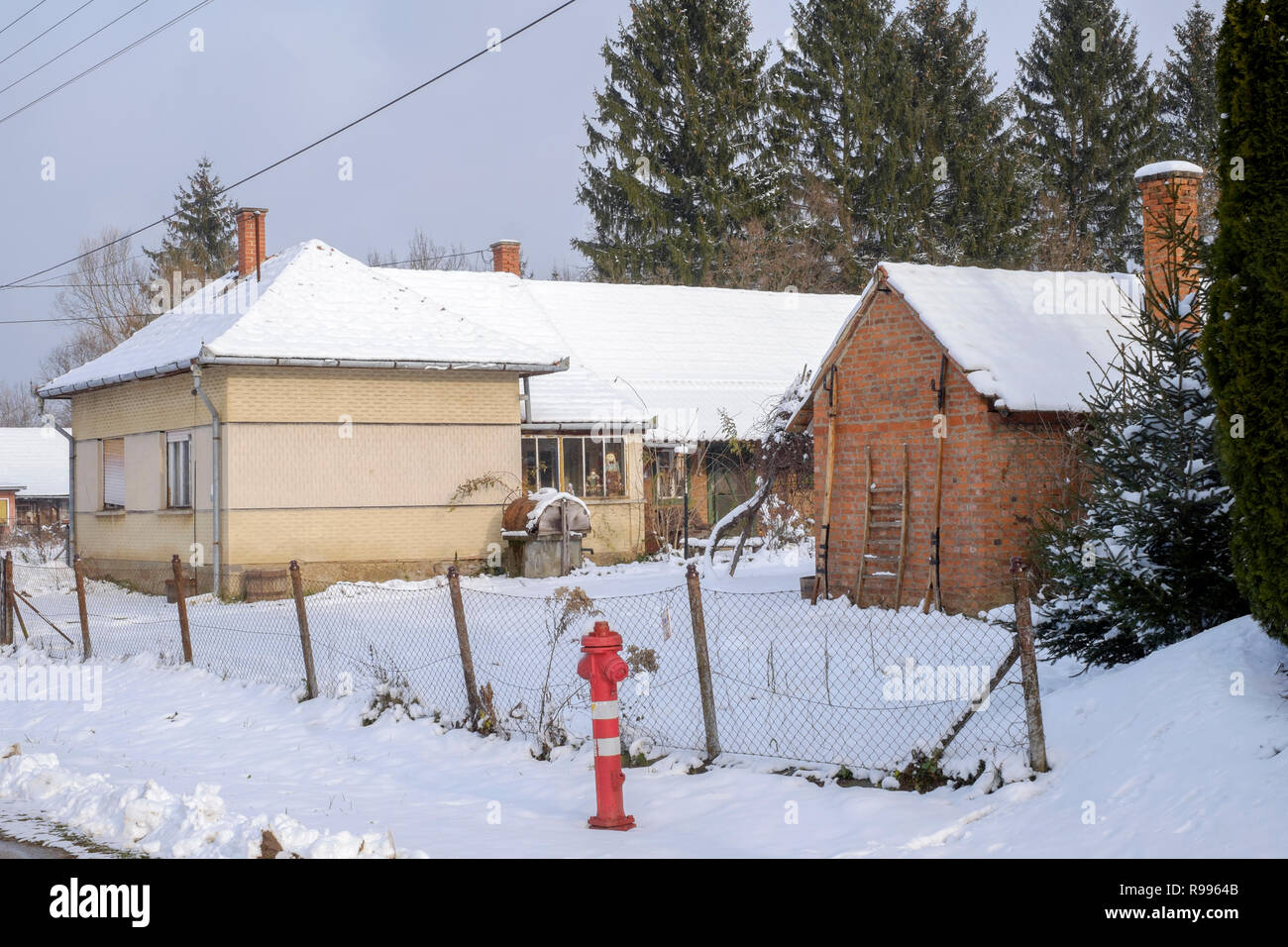 traditional house in a rural hungarian village covered in snow from a ...