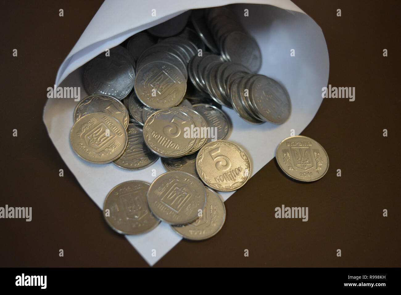 An envelope with money, in a white paper bag are small money, white ...