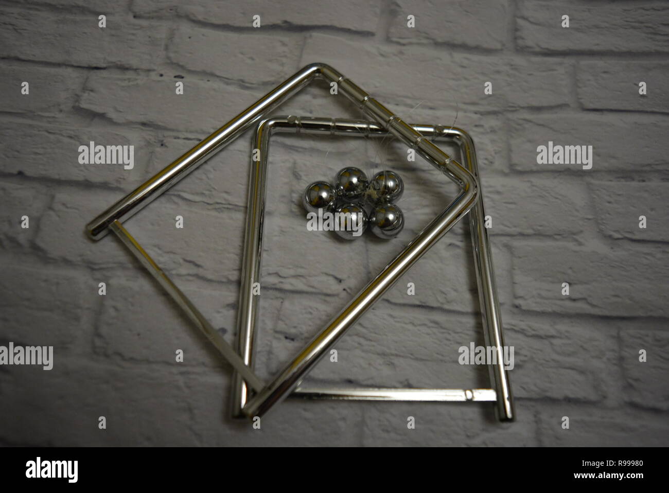 Tangled metal balls between themselves and fishing line with metal ...